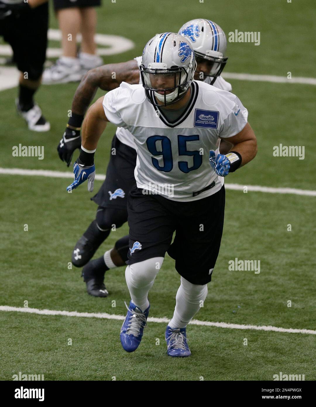 Detroit Lions linebacker Kyle Van Noy runs through an NFL football ...