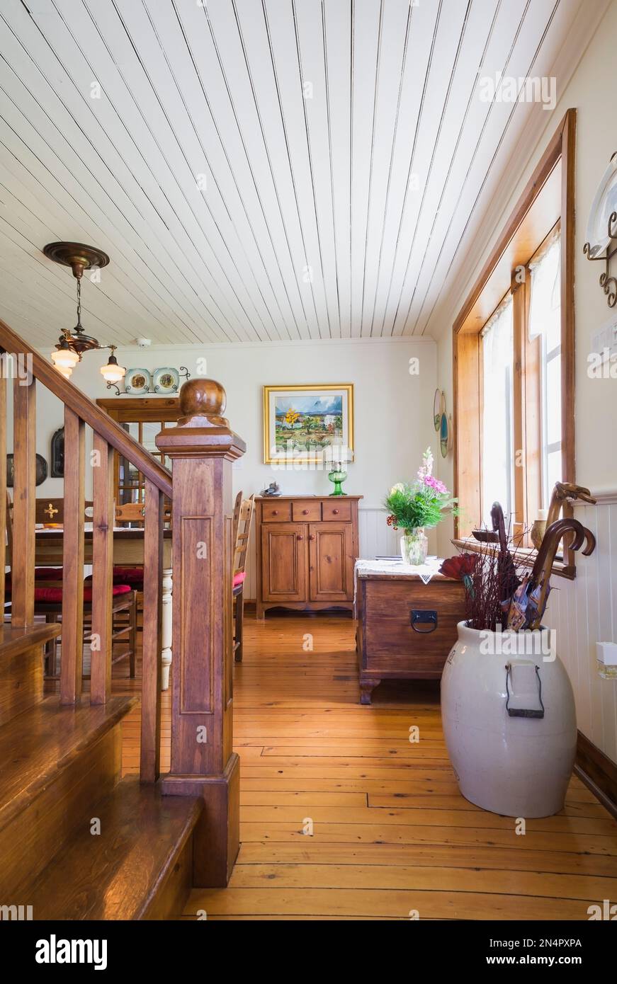 Brown stained pinewood stairs between living room and dining room ...