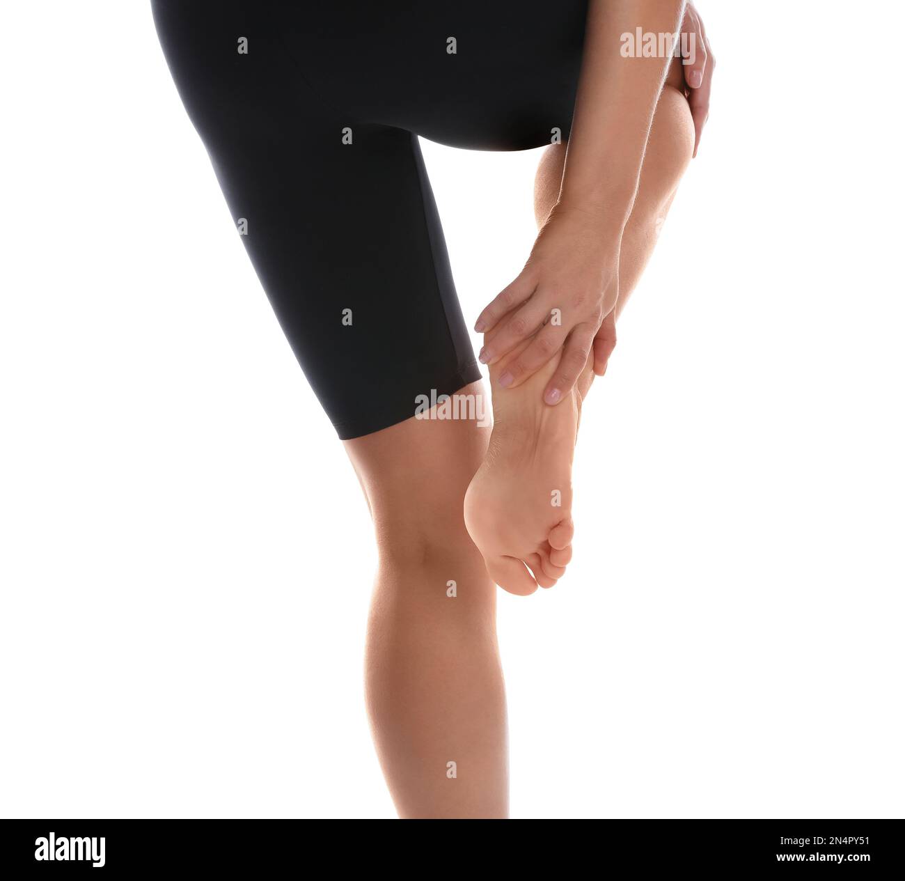 Back view of woman suffering from foot pain on white background ...