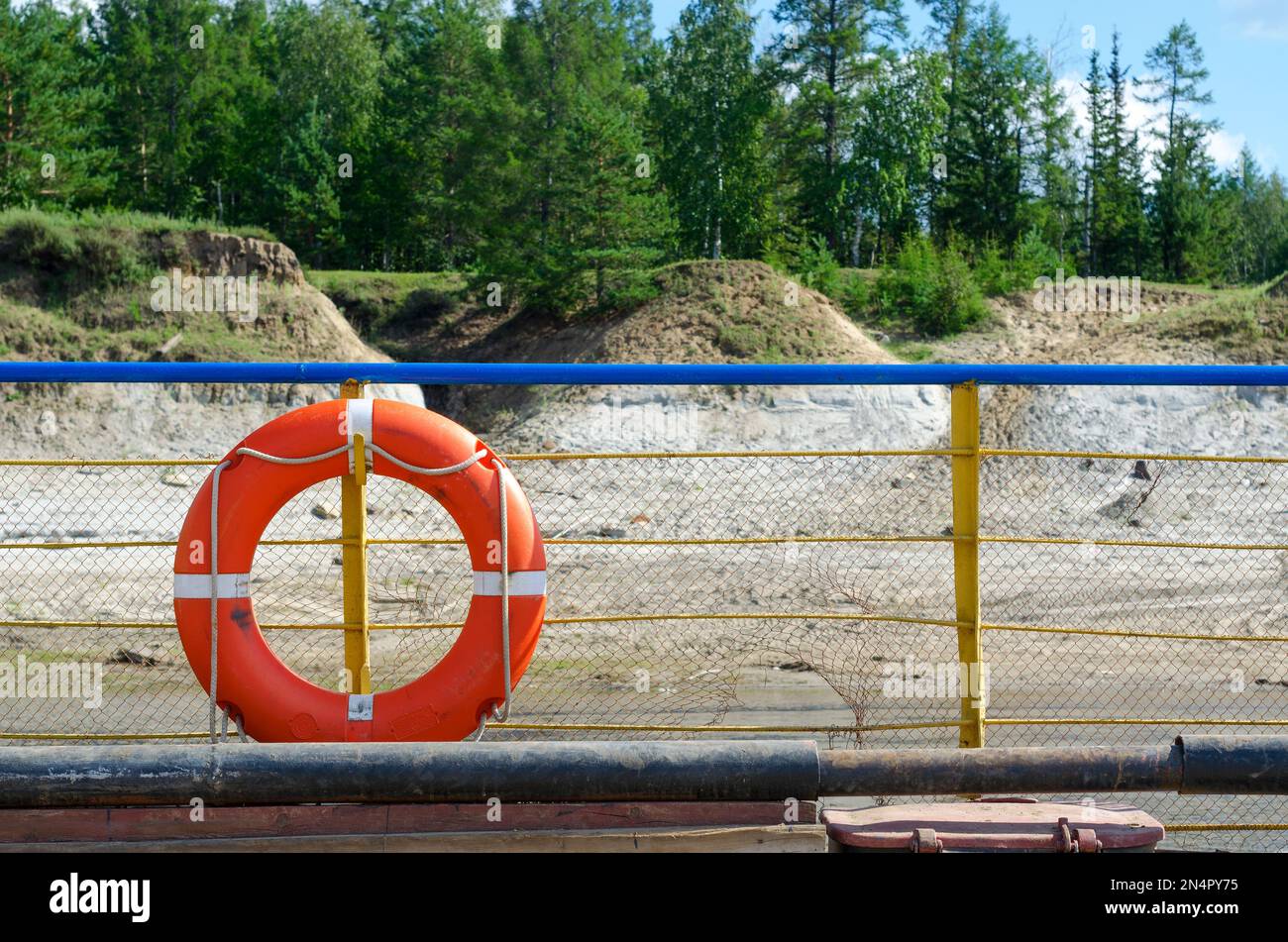 Orange life preserver attached to the deck railing of the ferry on the ...