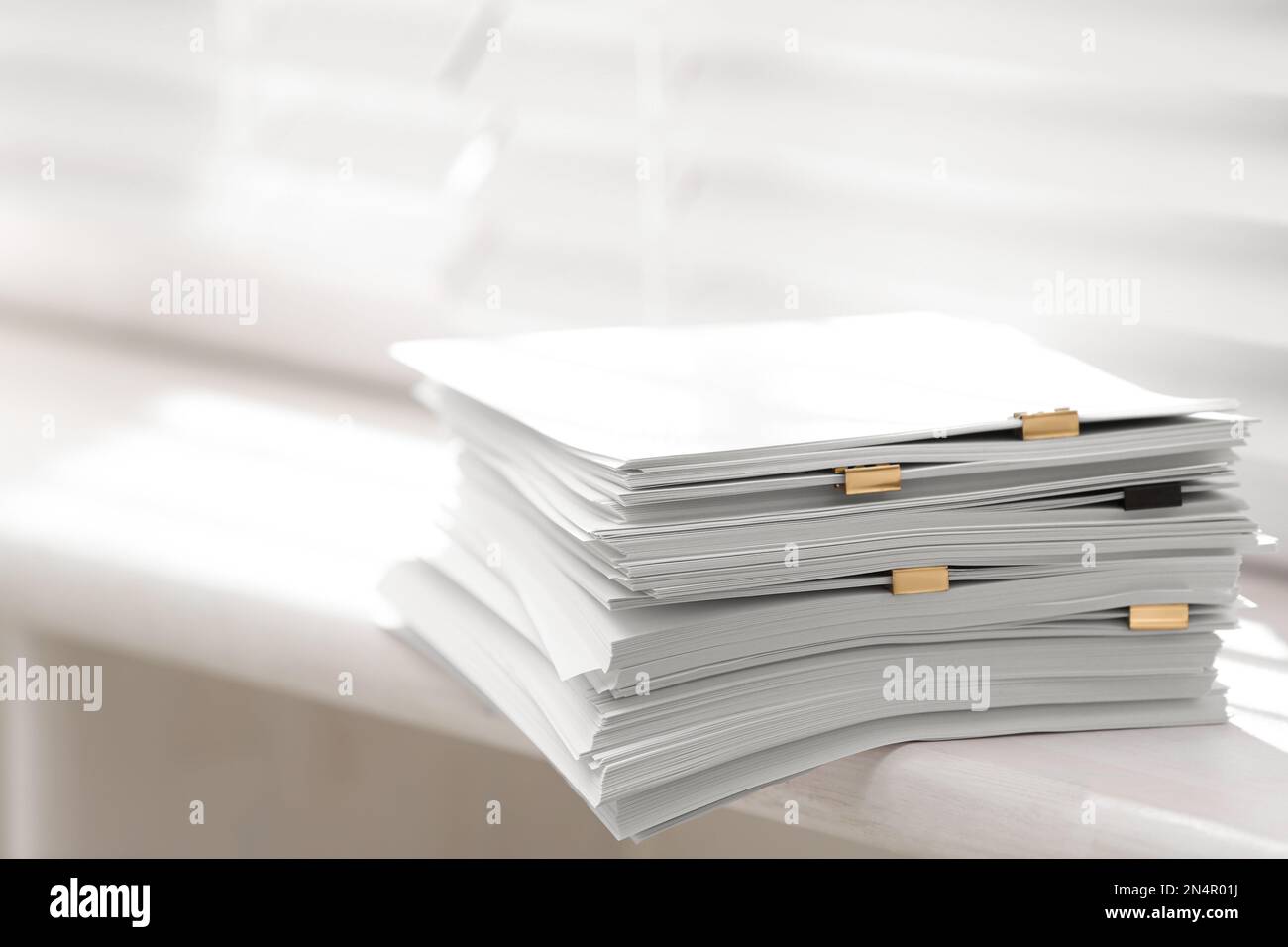 Stack of blank paper on window sill indoors Stock Photo - Alamy