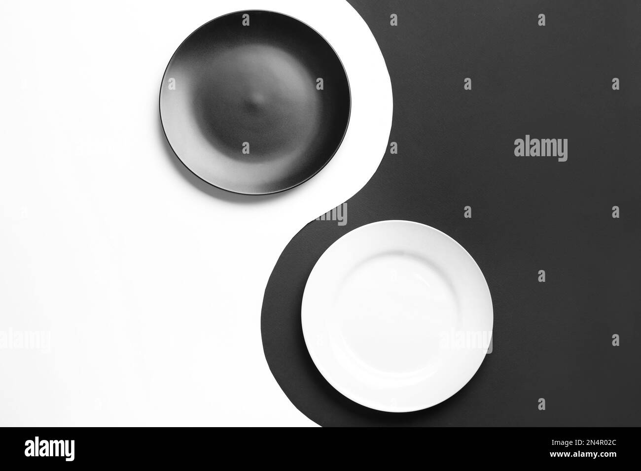Yin Yang symbol made with plates on color background, flat lay. Zen ... Yin Yang symbol made with plates on color background, flat lay. Zen ...