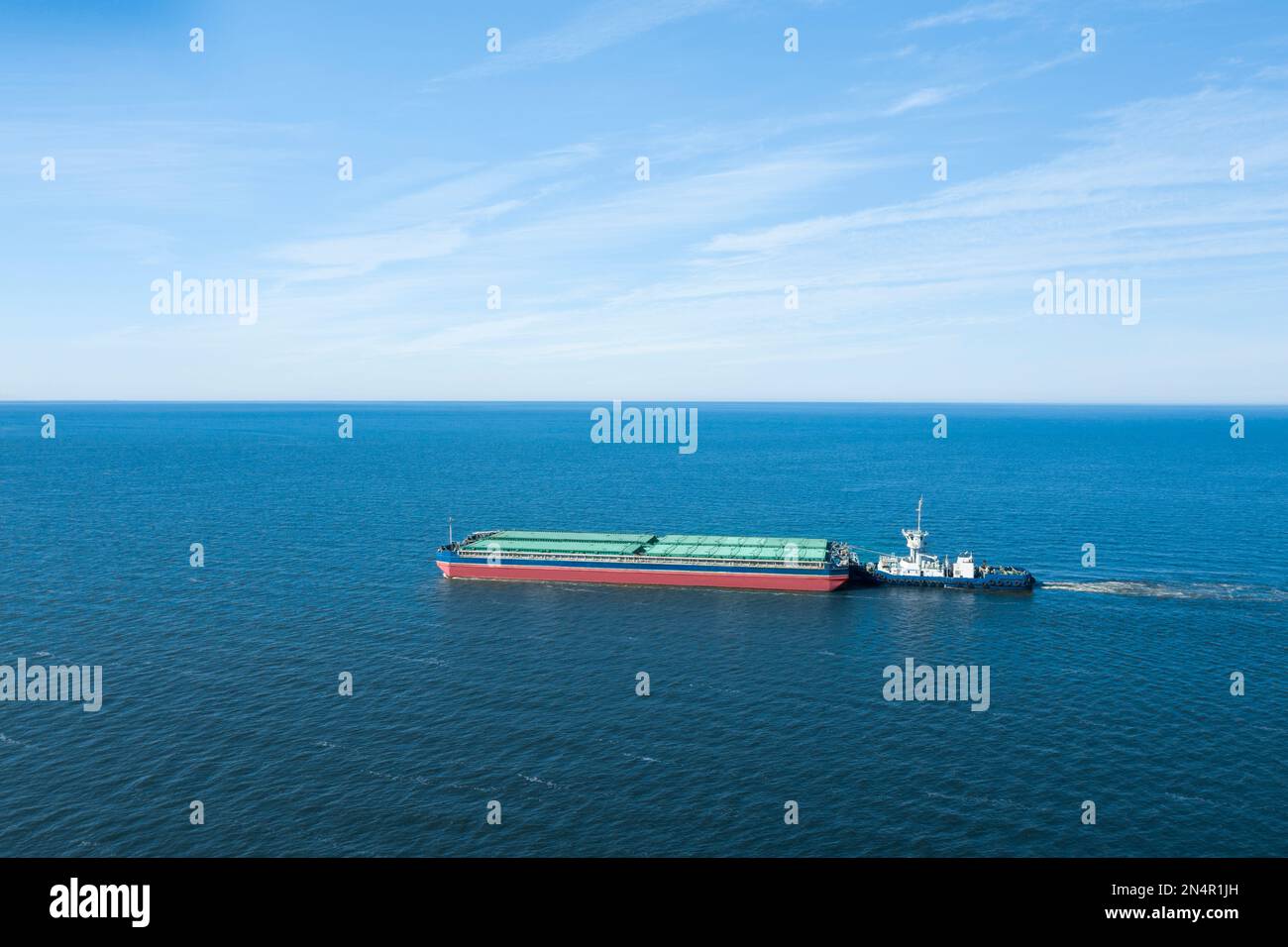 Tugboat pulling barge with cargo by water, aerial view Stock Photo - Alamy