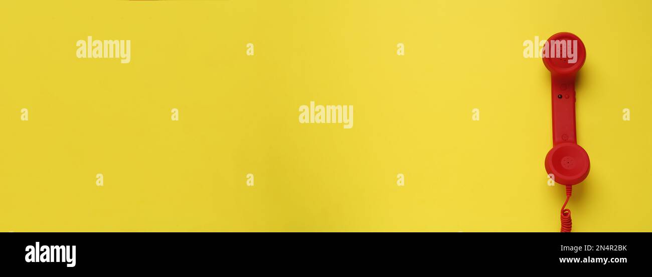 Hotline service. Red telephone receiver and space for text on yellow ...