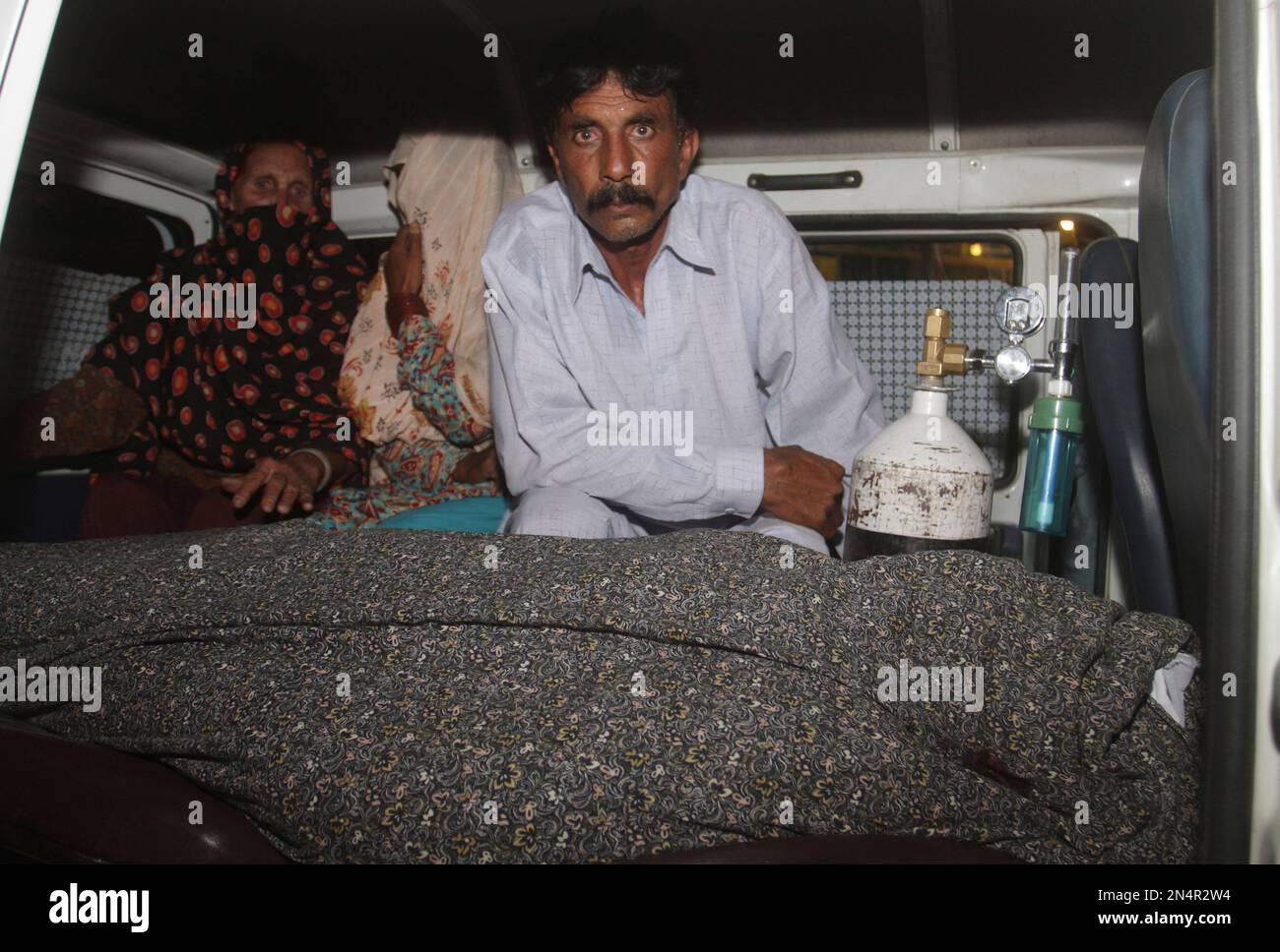 Mohammad Iqbal, right, husband of Farzana Parveen, 25, sits in an ...