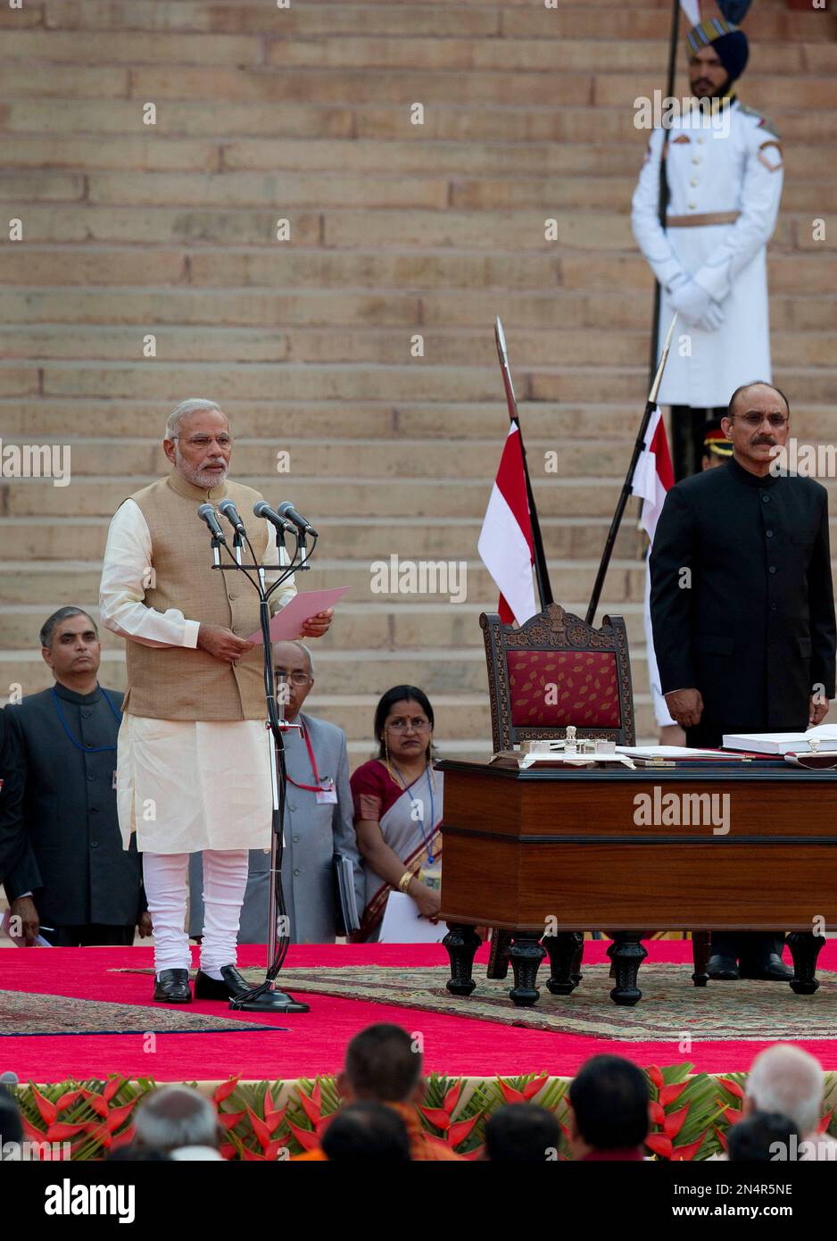 India's new Prime Minister Narendra Modi, left, takes the oath of ...
