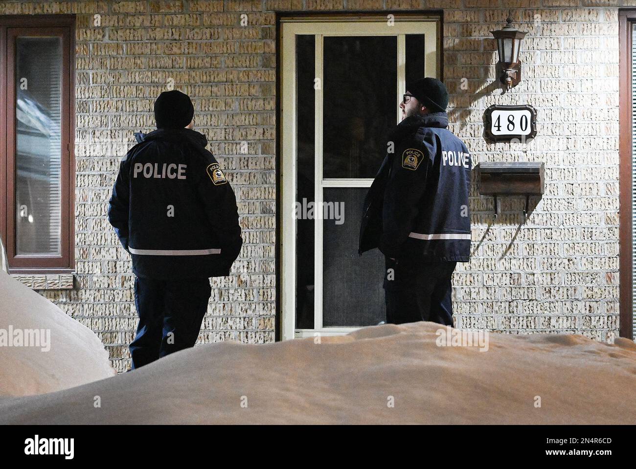 Police are shown outside the home of Pierre Ny St-Amand in Laval, Que ...