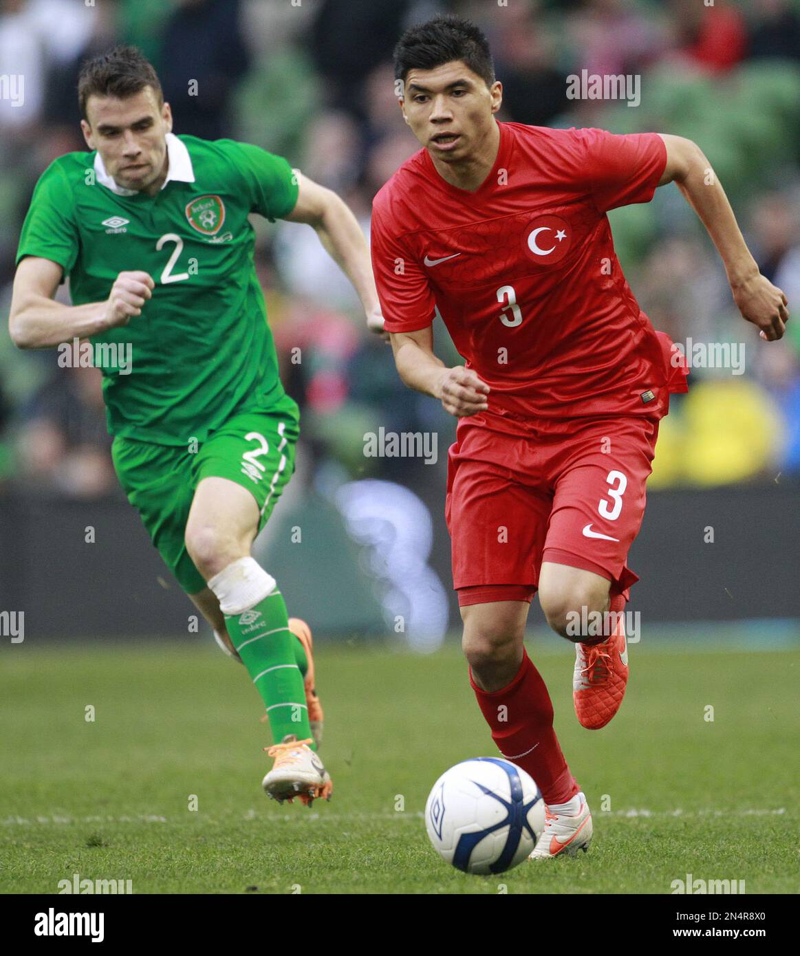 Turkey's Ishak Dogan, right, makes his way past Republic of Ireland's ...