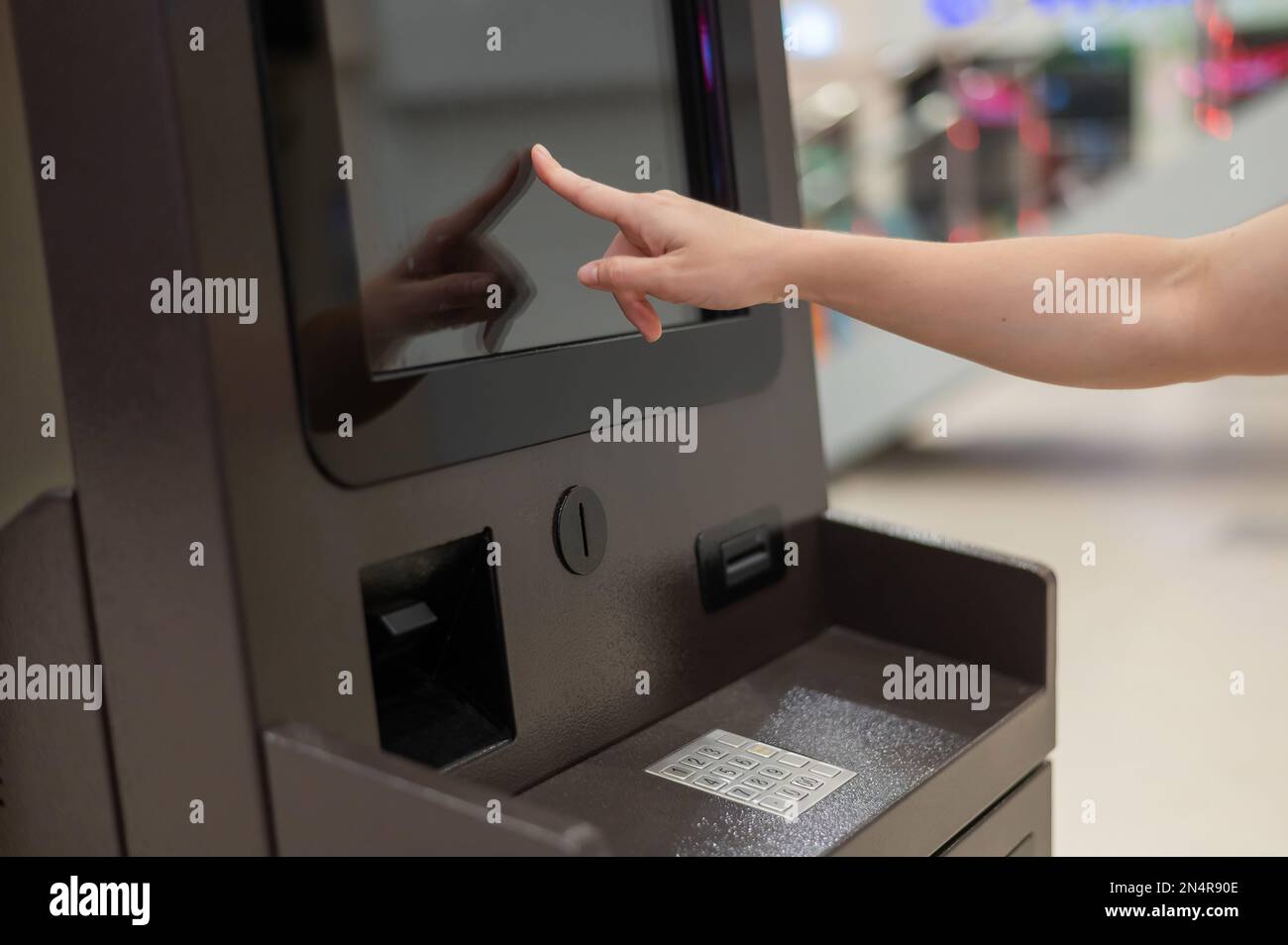 Faceless woman using touchscreen ATM Stock Photo - Alamy