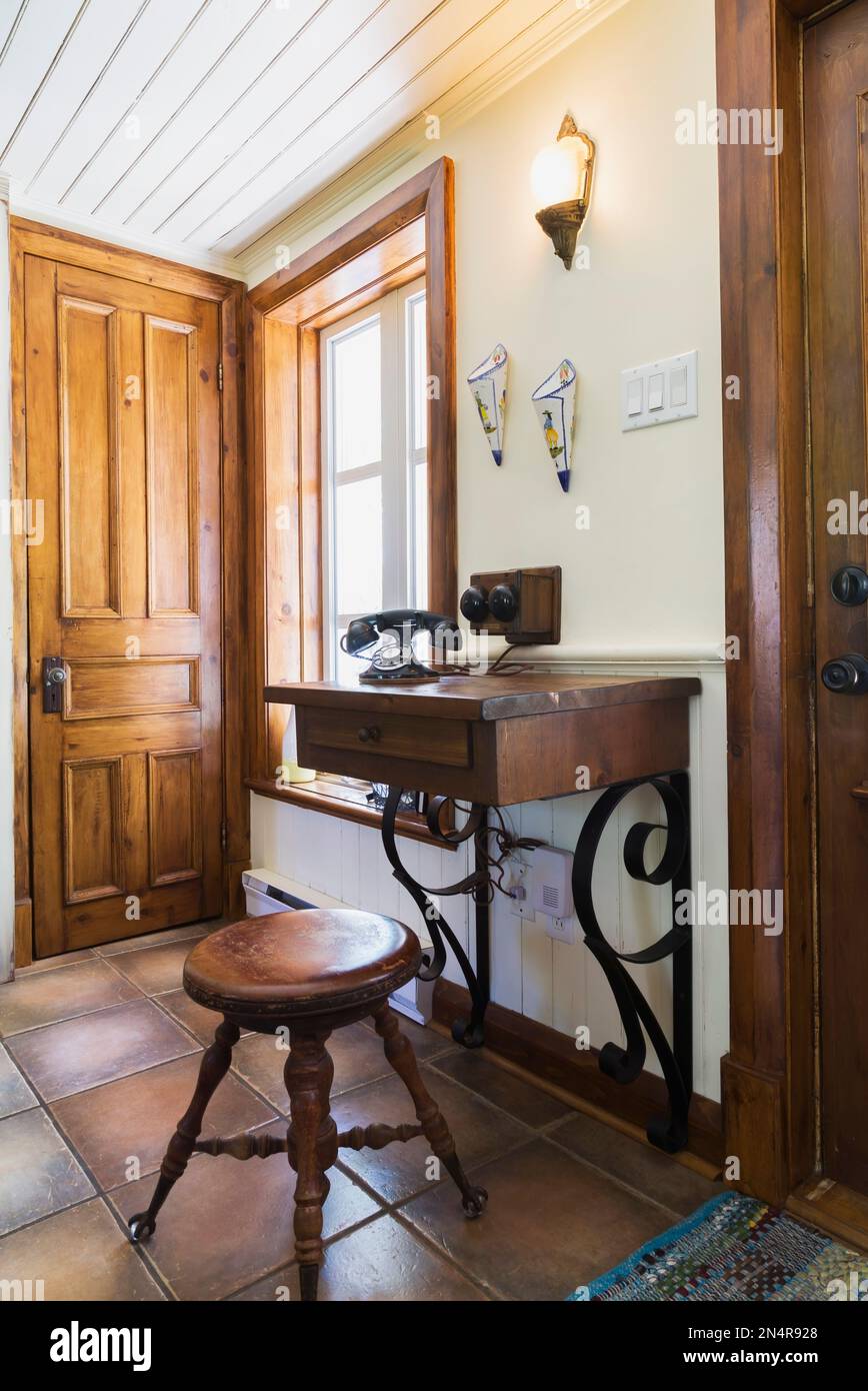 Old wooden stool and wall mounted desk table with fixed-line black ...