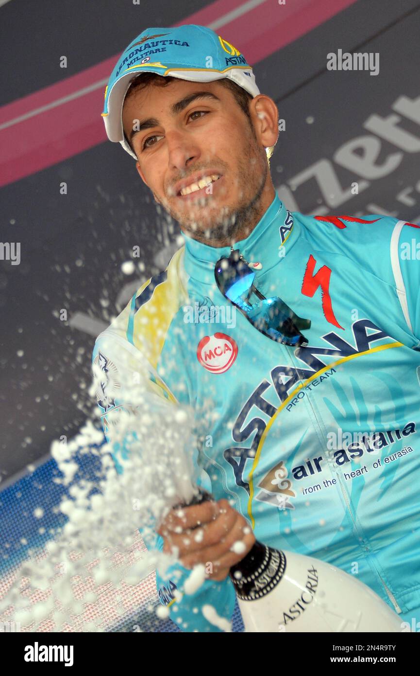 Italy's Fabio Aru celebrates on podium after winning the 15th stage of ...