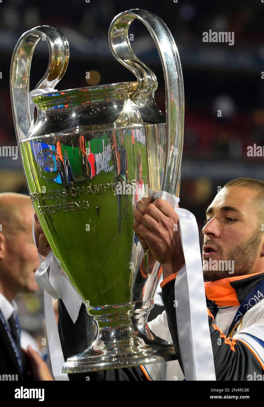 Real's Karim Benzema lifts the Champion League trophy, at the end of ...