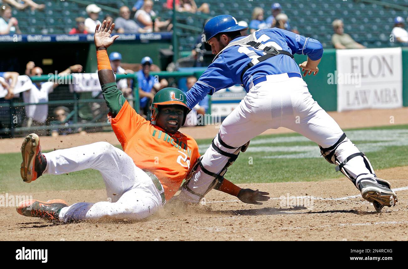 Miami's Jacob Hayward (28) slides safely into home as Duke catcher Mike ...