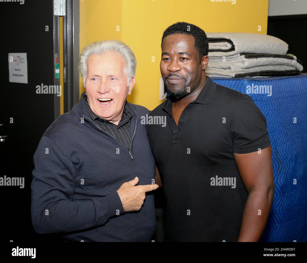 From left, actor Martin Sheen congratulates writer/cast member Daniel ...