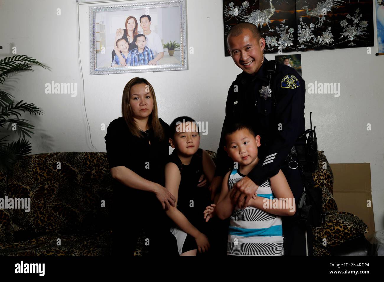 In this May 21, 2014 photo, San Jose police officer Huan Nguyen, right ...