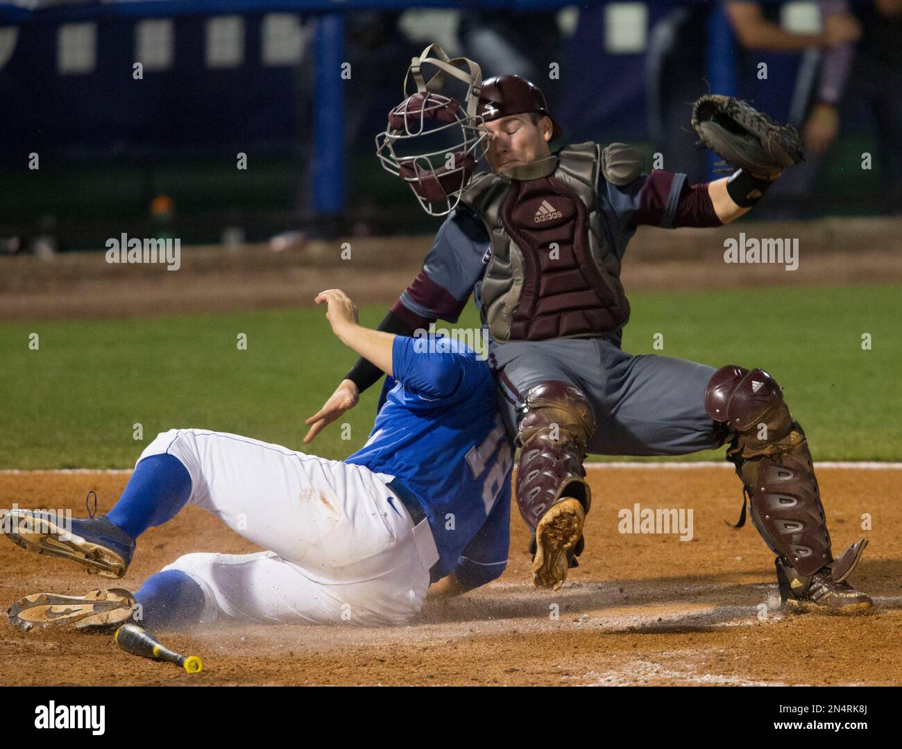 Kentucky's A.J. Reed, left, collides with Mississippi State catcher ...