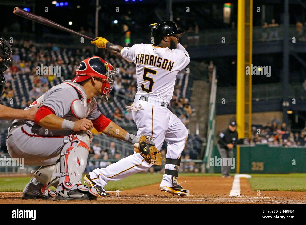 Pittsburgh Pirates' Josh Harrison,right, drives in a run with a single ...