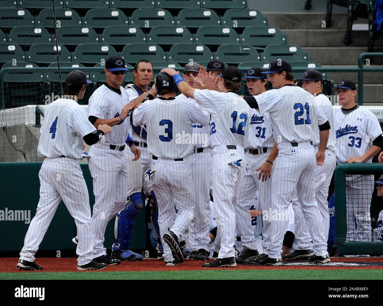 Creighton's Jake Peter (3) is greeted at the dugout after scoring on a ...