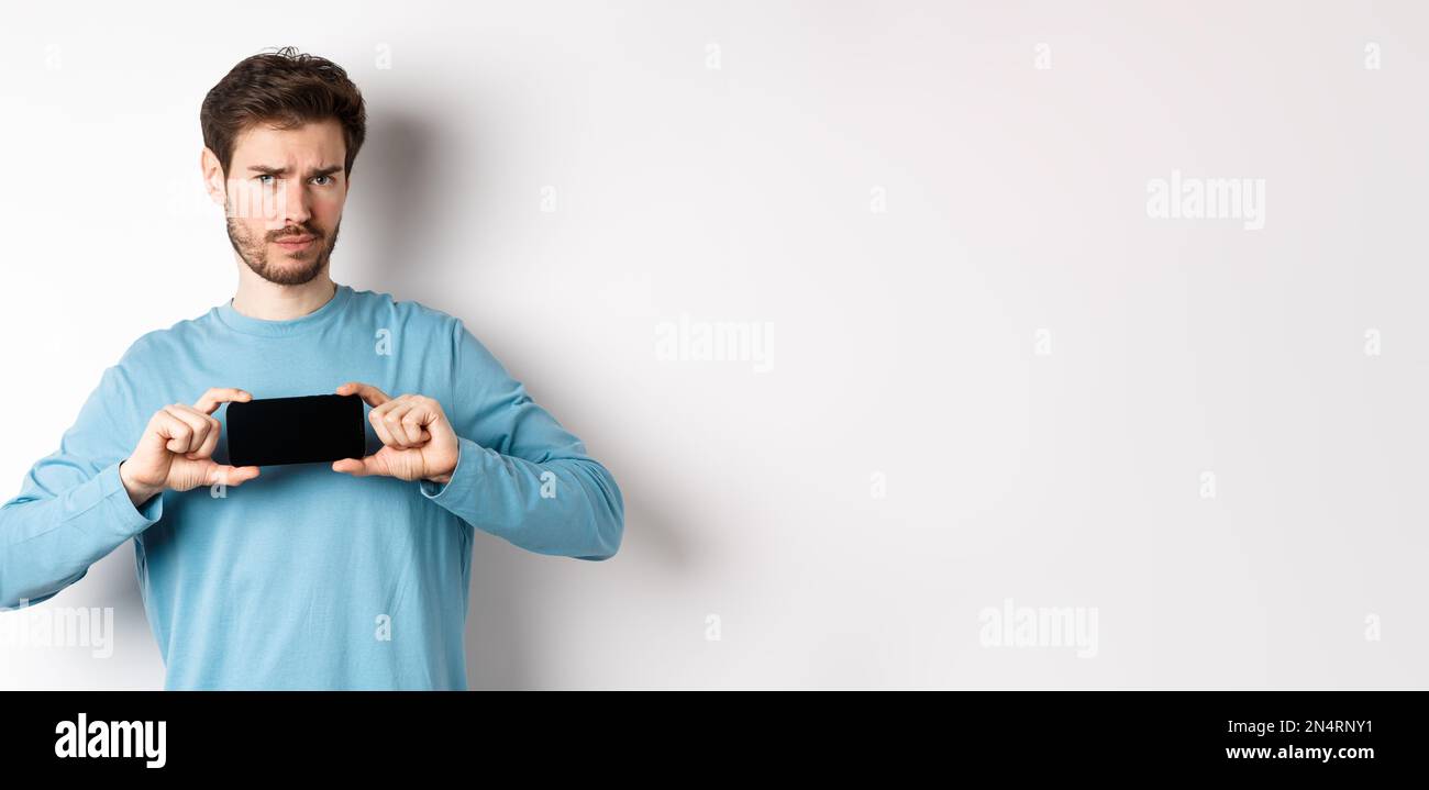 E-commerce and shopping concept. Sad and disappointed guy complaining ...