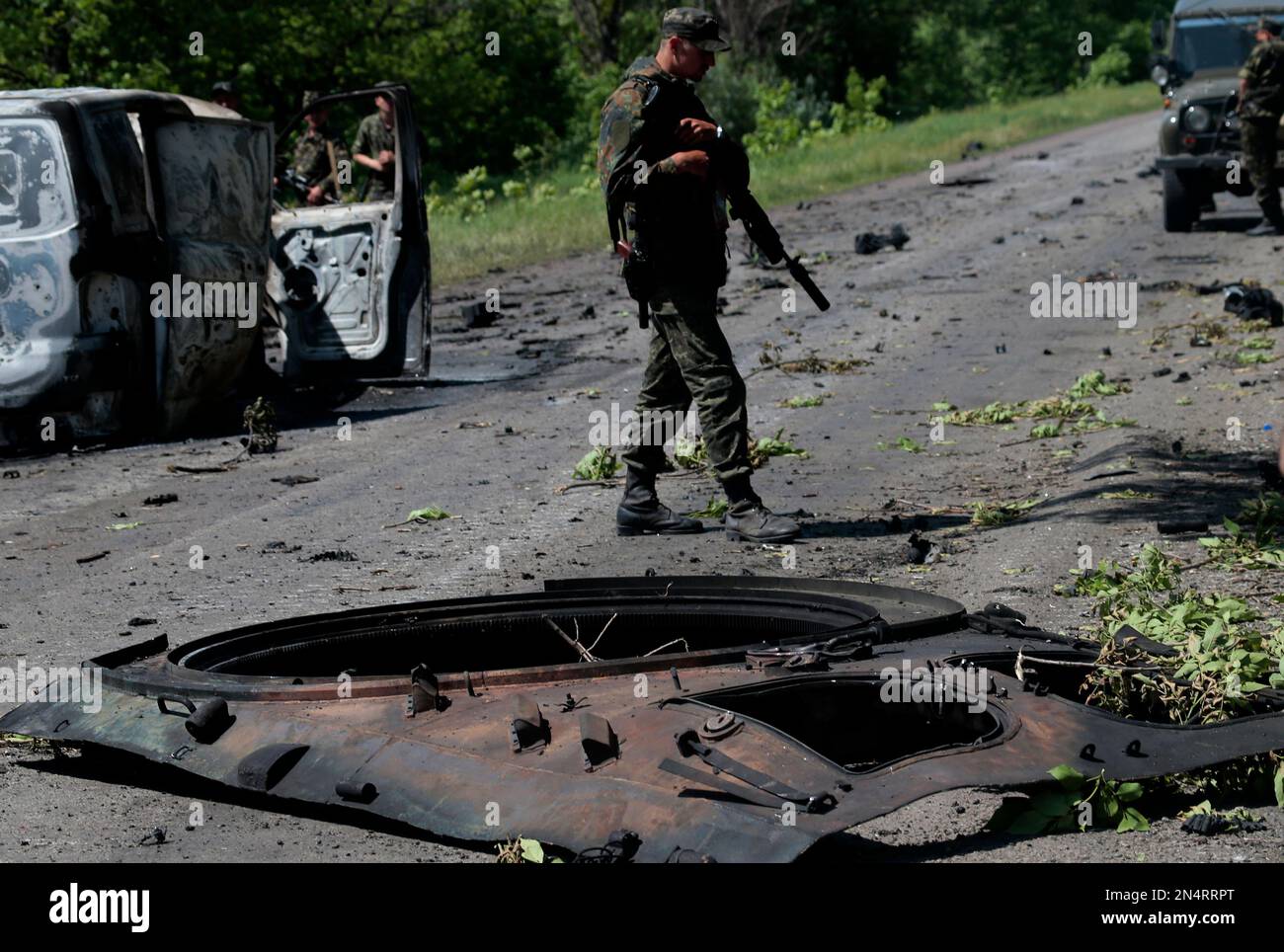 An Ukrainian soldier walks at a gunfight site near the village of ...