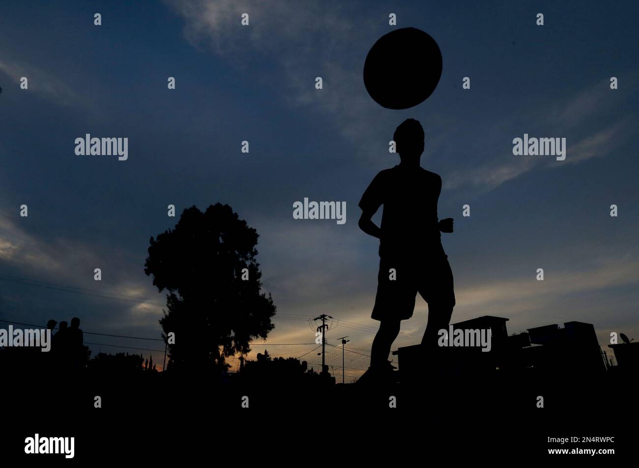Ulises Alvarez, 16, chases after a ball during a pick-up soccer game ...