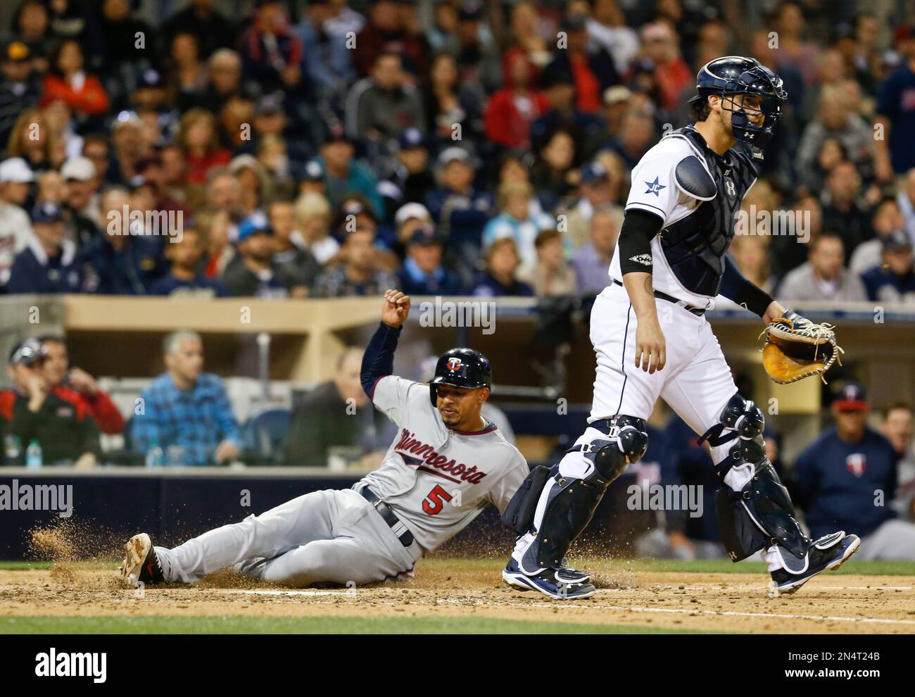 Minnesota Twins' Eduardo Escobar, left, slides in safely while scoring ...