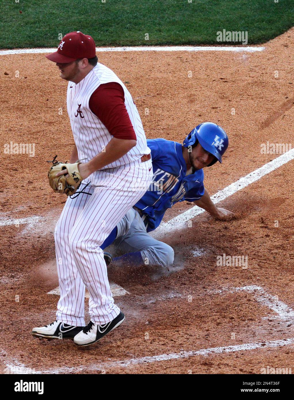 Kentucky's Matt Reida (6) slides safely into home on a bad pitch by ...