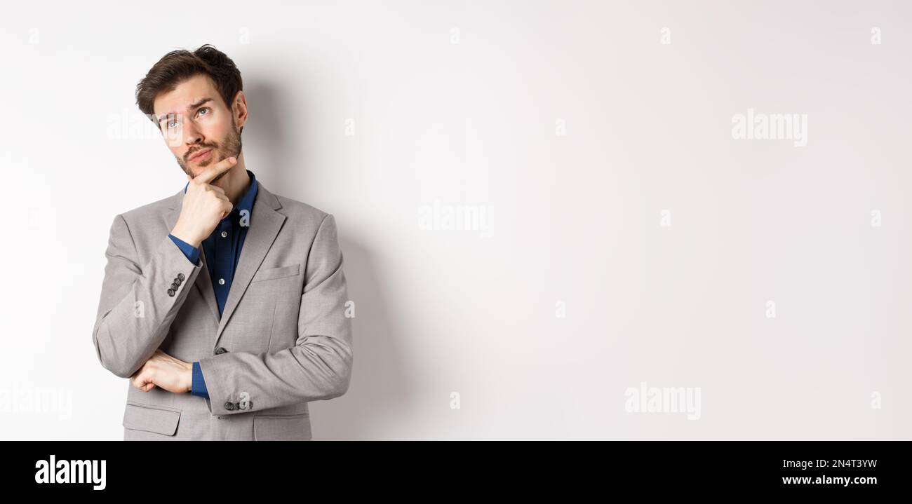 Thoughtful businessman in grey suit look at upper left corner logo ...