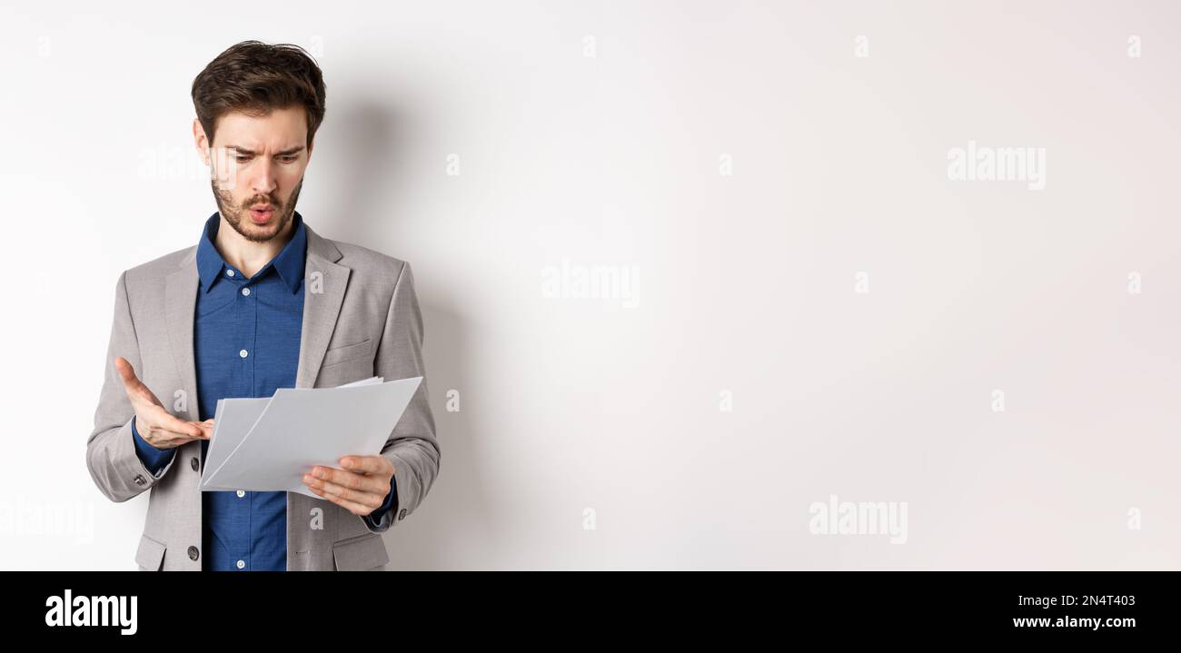 Confused businessman looking at bad document, complaining on deal ...