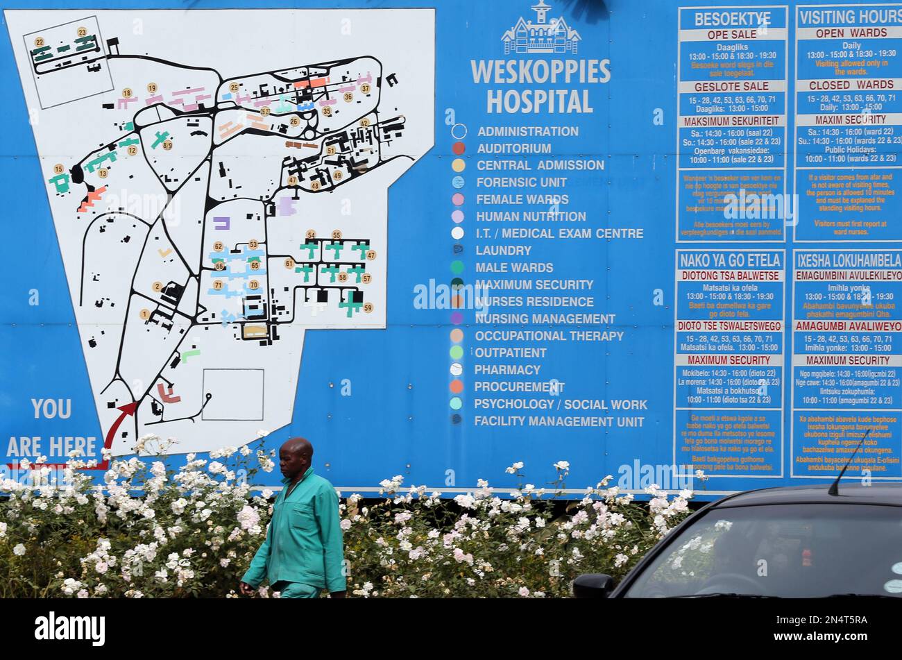 A man walks past a direction board at the Weskoppies Psychiatric ...