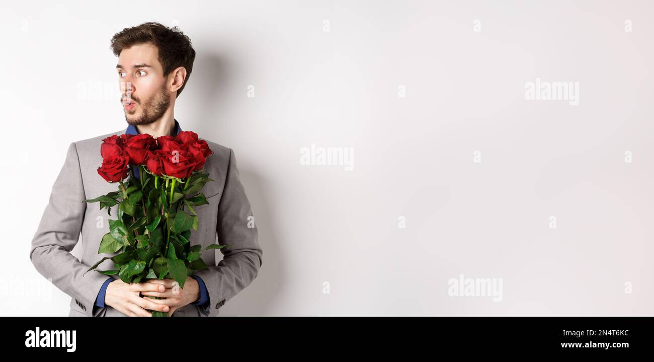 Nervous boyfriend waiting for his date on valentines day, looking left ...