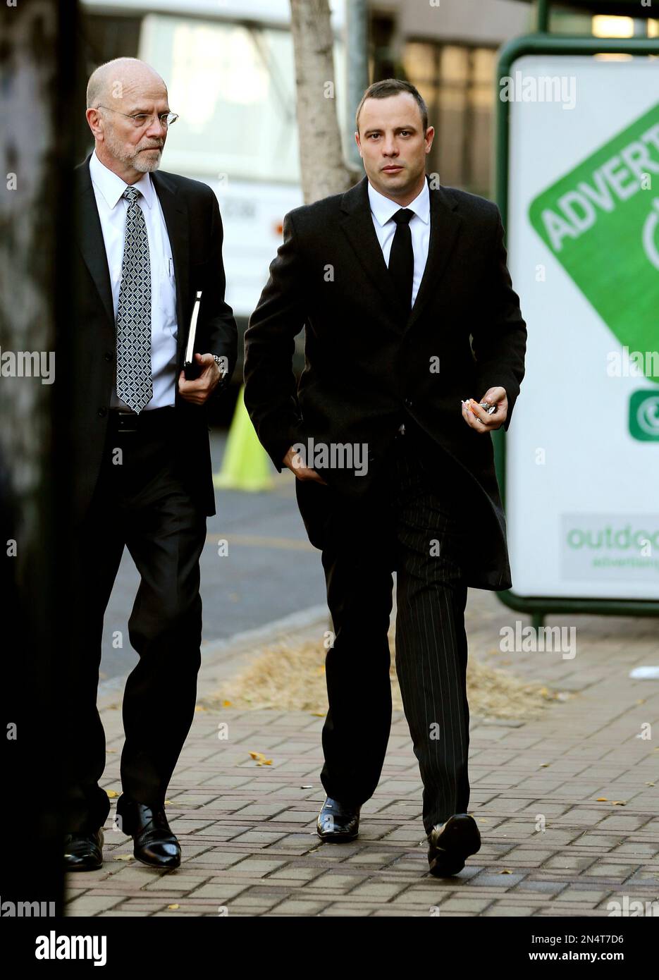 Oscar Pistorius, right, accompanied by his uncle Arnold Pistorius ...