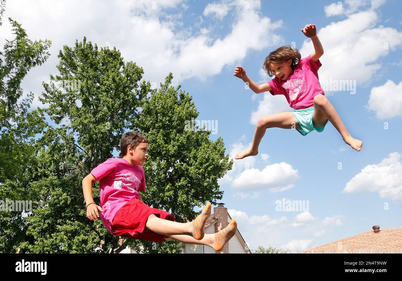 Xavier Delgado, left, and his sister, Haley Delgado, right, play on the ...