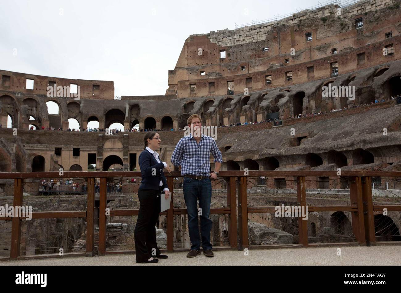 Britain's Prince Harry, right, listens to Italian guide Laura Ciglioni ...