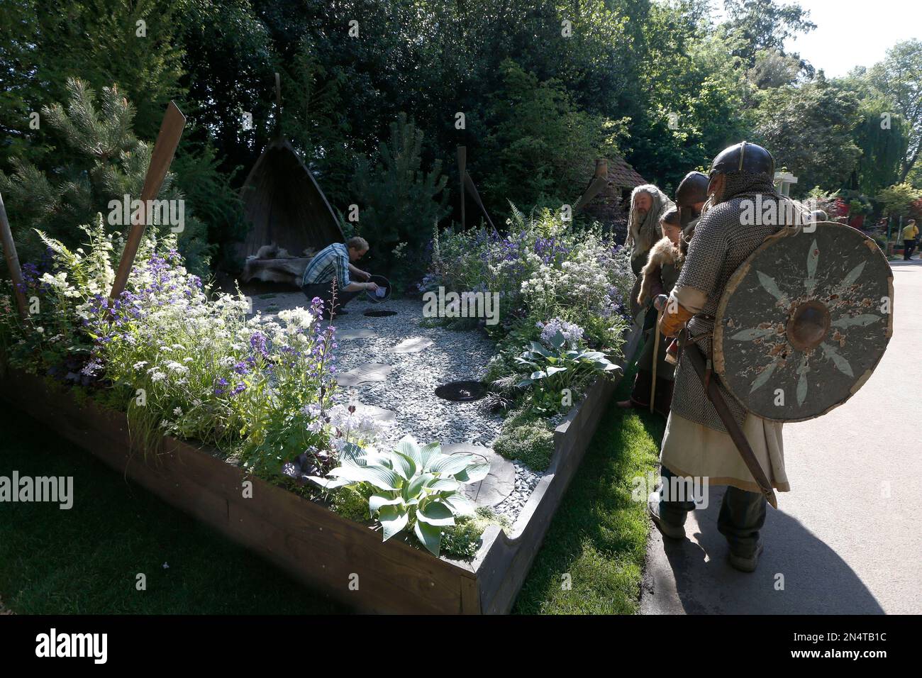 A gardener works in an artisan garden 'The Viking Cruises Norse Garden ...