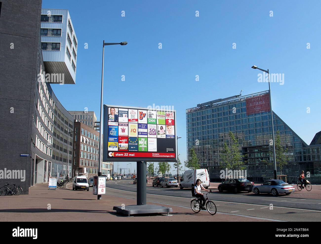 A girl cycles past campaign posters for political parties participating ...