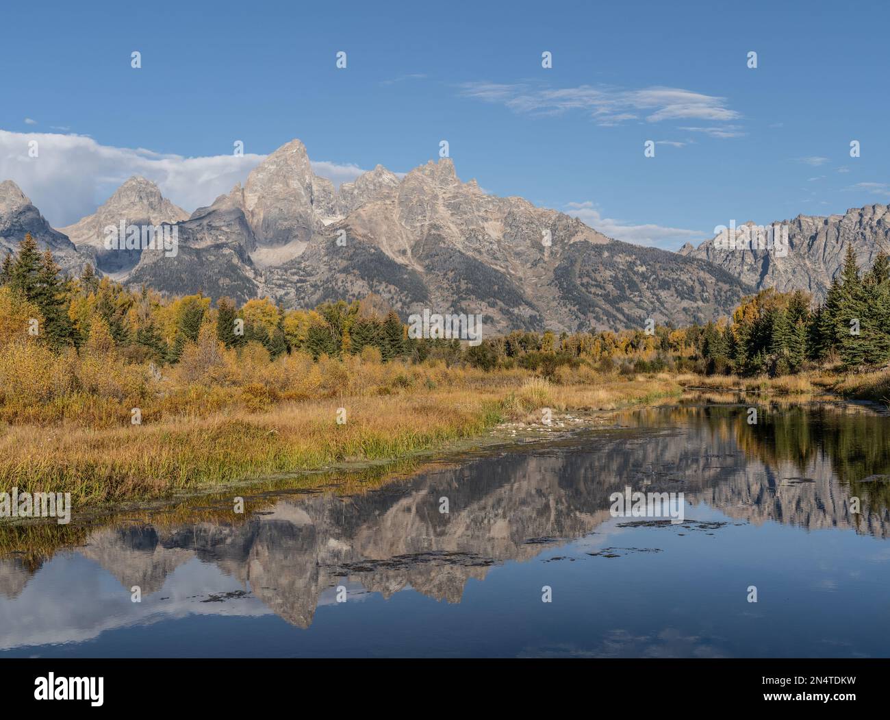 Grand Teton Mountain Range with autumn colors reflect in water of Snake ...