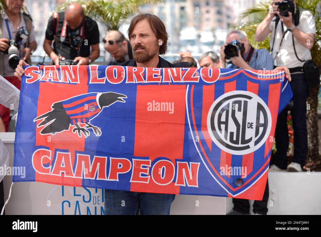 Viggo Mortensen waves a flag during a photo call for Jauja at the 67th ...