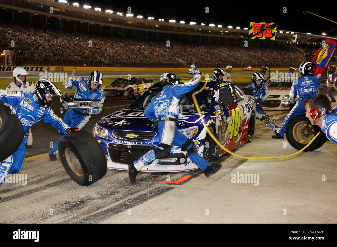 Crew members perform a pit stop on driver Jimmie Johnson's Car during ...