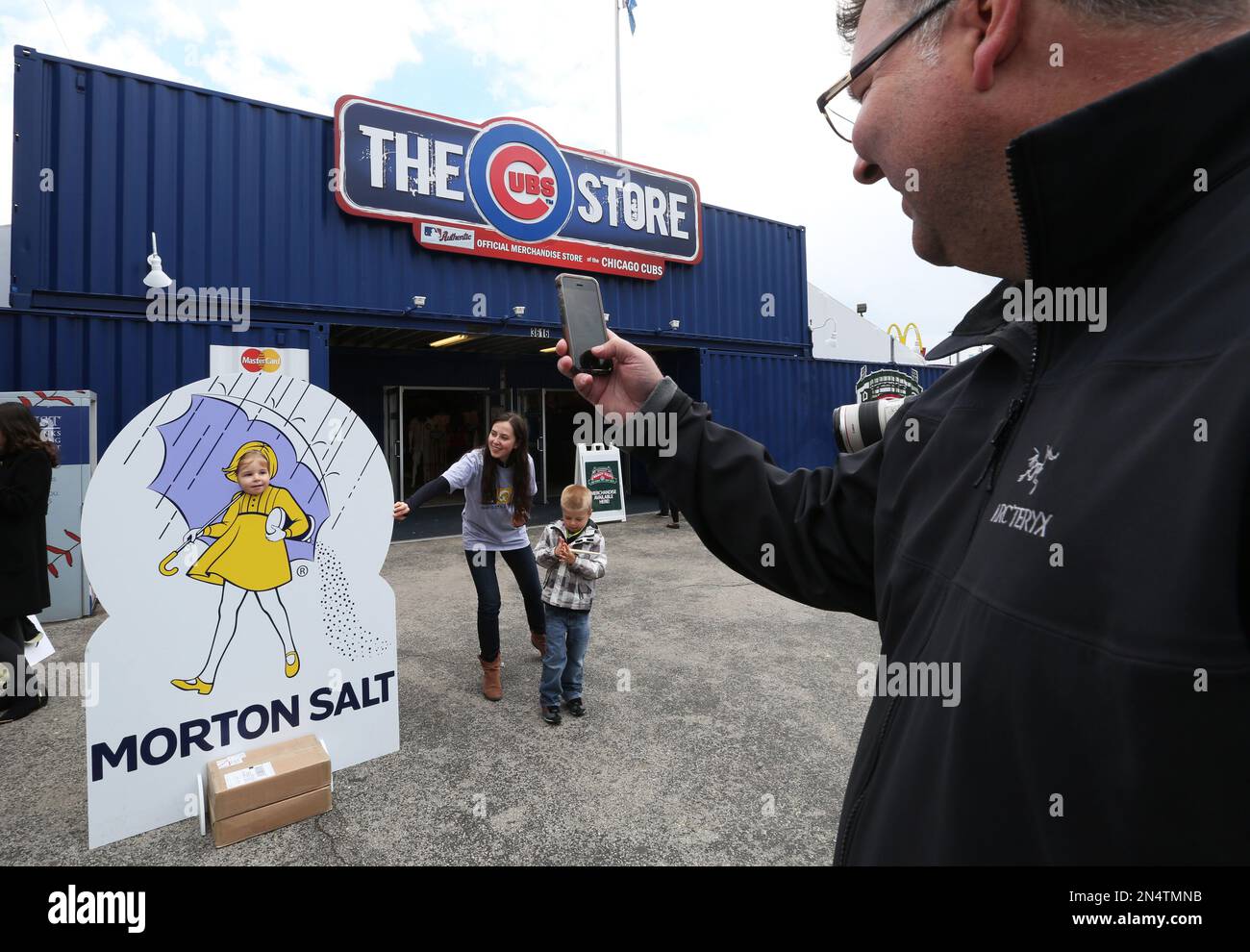 A family captures a moment with a Morton Salt Girl cutout outside ...