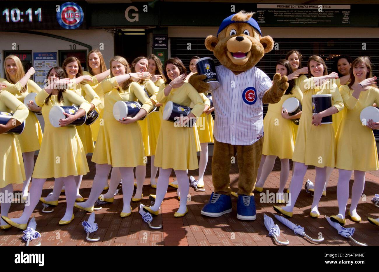 Clark, the Cubs new mascot, stands with the Morton Salt Girls as they ...