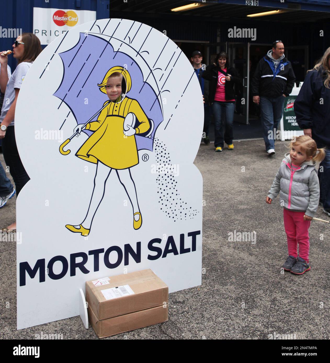 A child poses in a Morton Salt Girl cutout outside Wrigley Field on ...