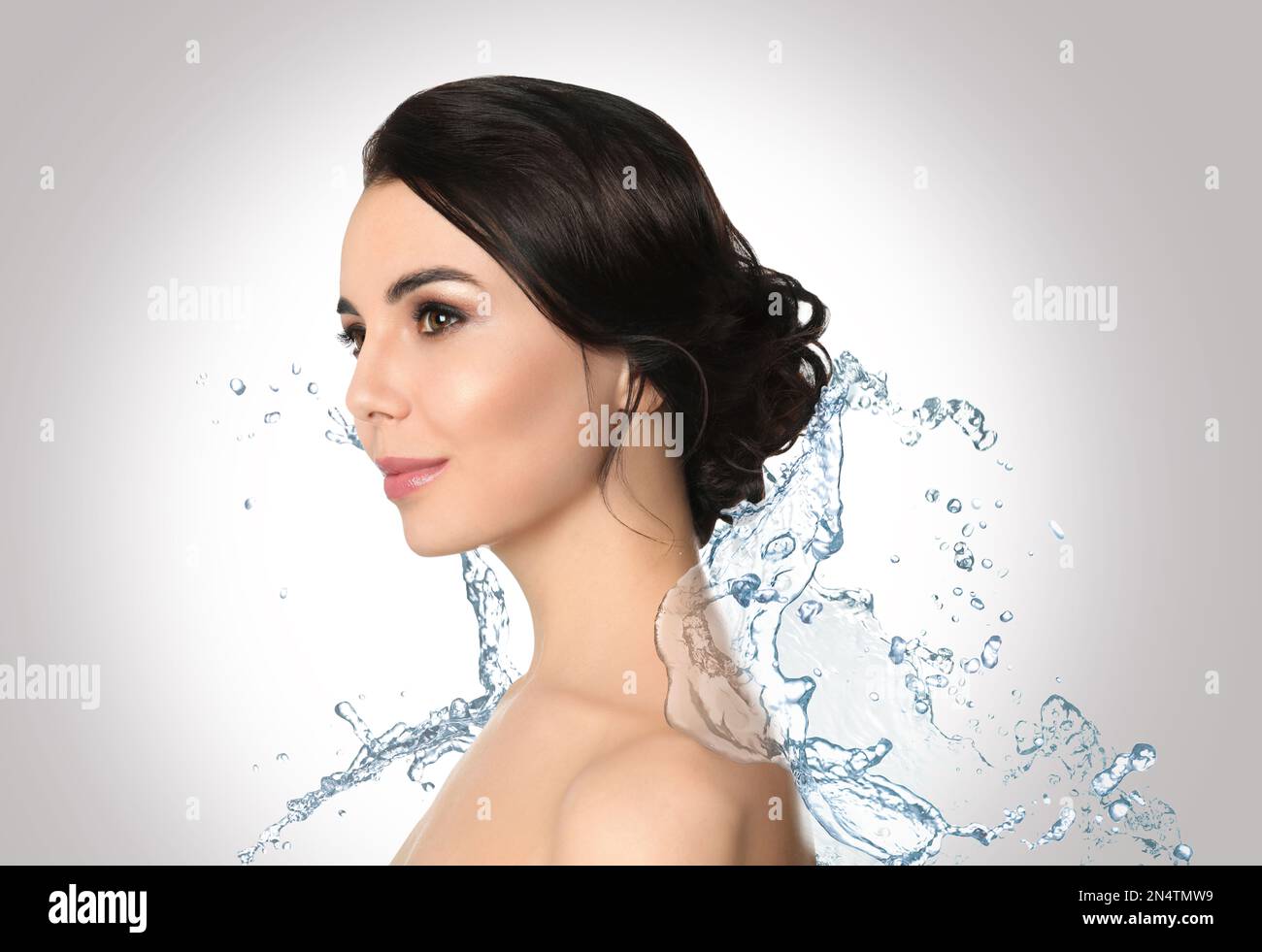 Beautiful young woman and splashing water on light background. Spa ...