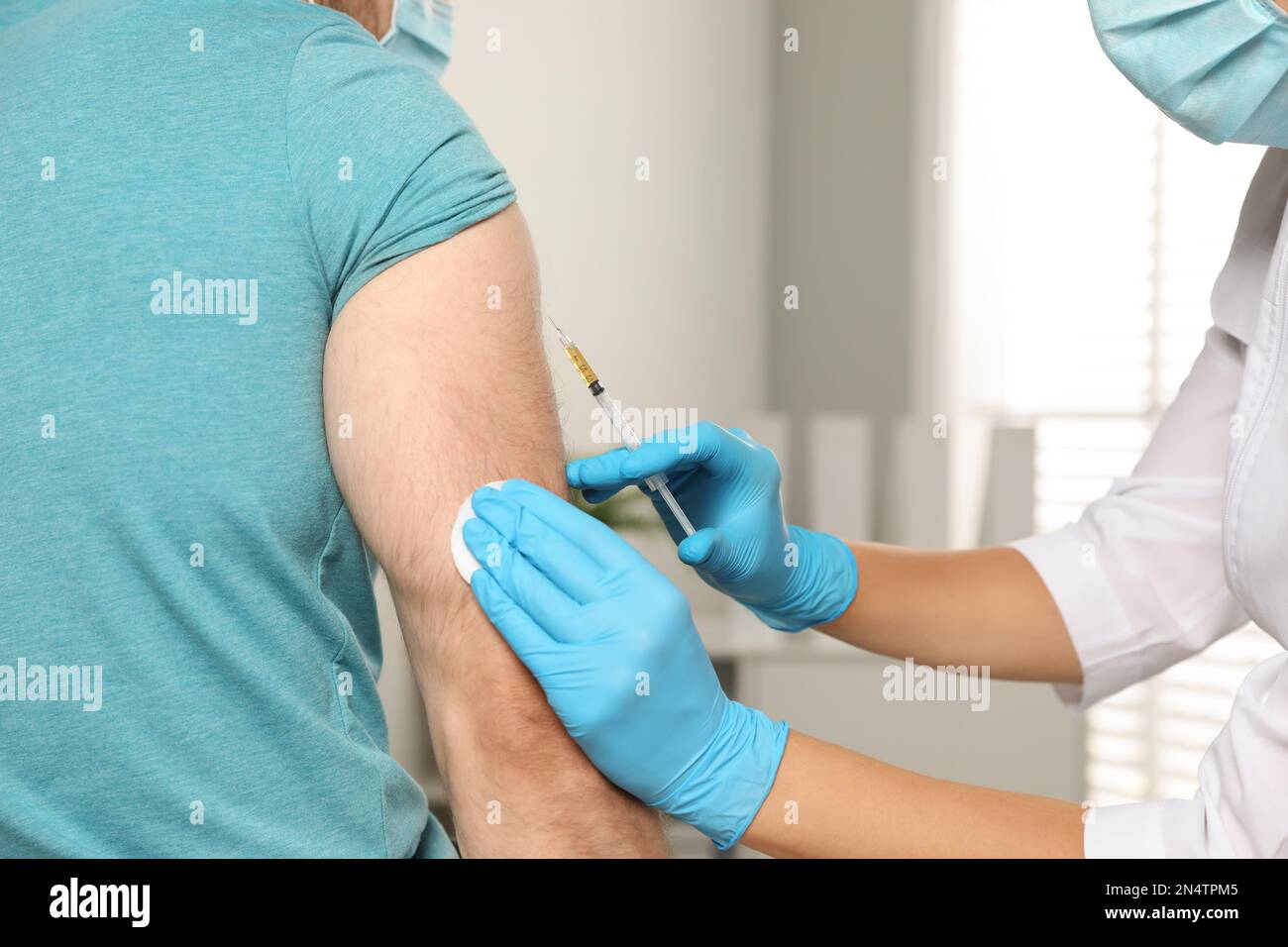 Doctor giving injection to patient in hospital, closeup. Vaccination ...