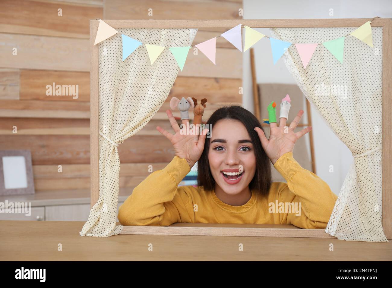 Young woman performing puppet show at home Stock Photo - Alamy