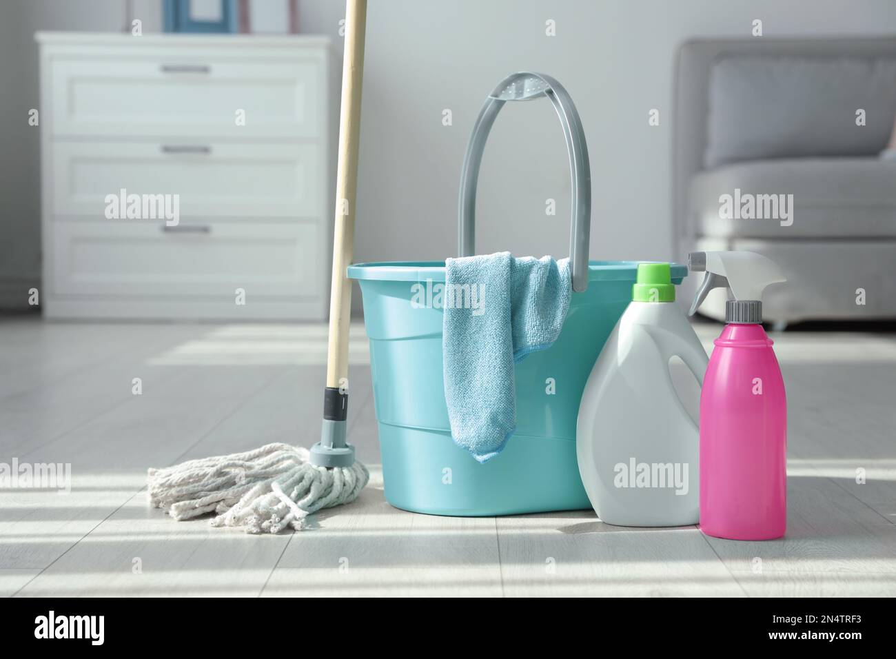 Bucket, mop and cleaning supplies on floor indoors Stock Photo - Alamy