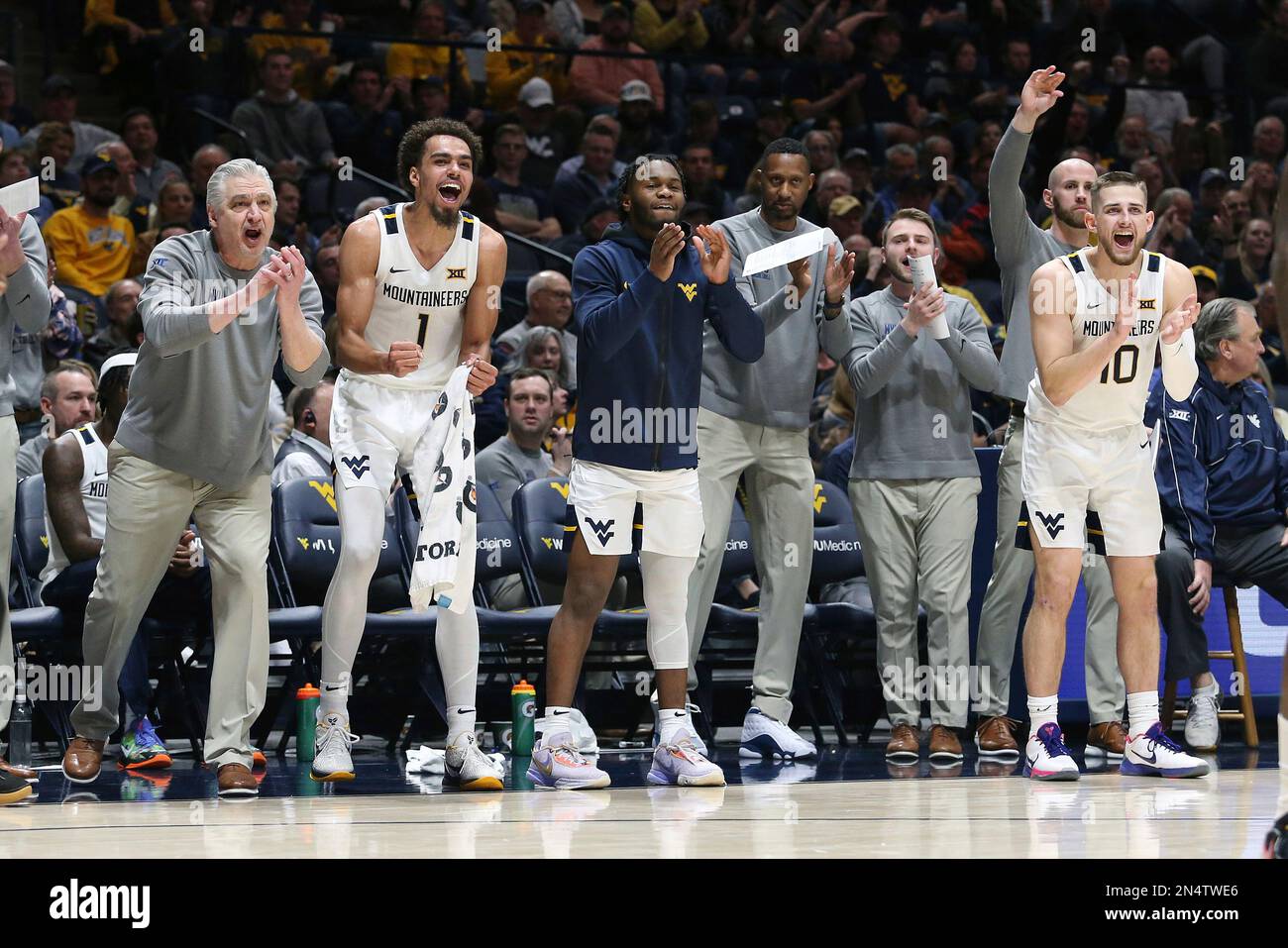 West Virginia players and coaching staff react from the bench during ...