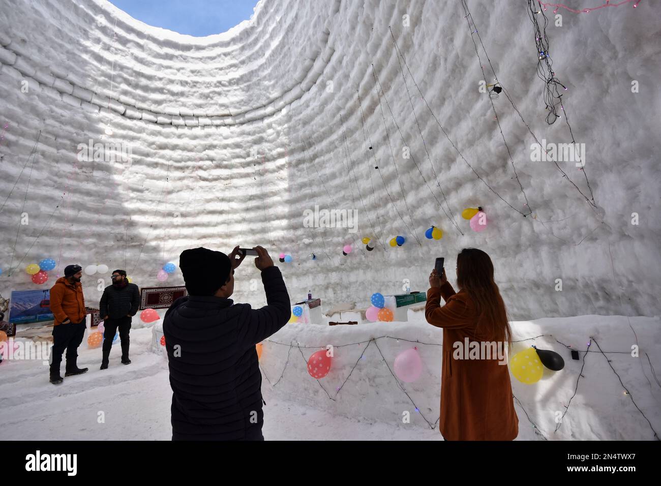 Indian tourists take their photos inside an Igloo cafe in Ski resort ...