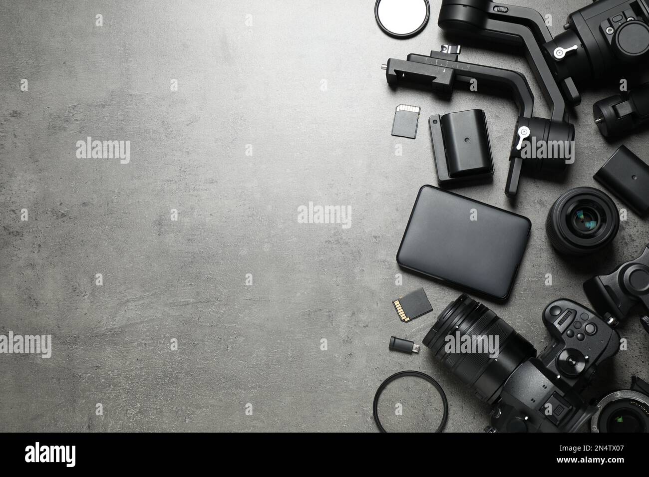 Camera and video production equipment on grey stone background, flat ...