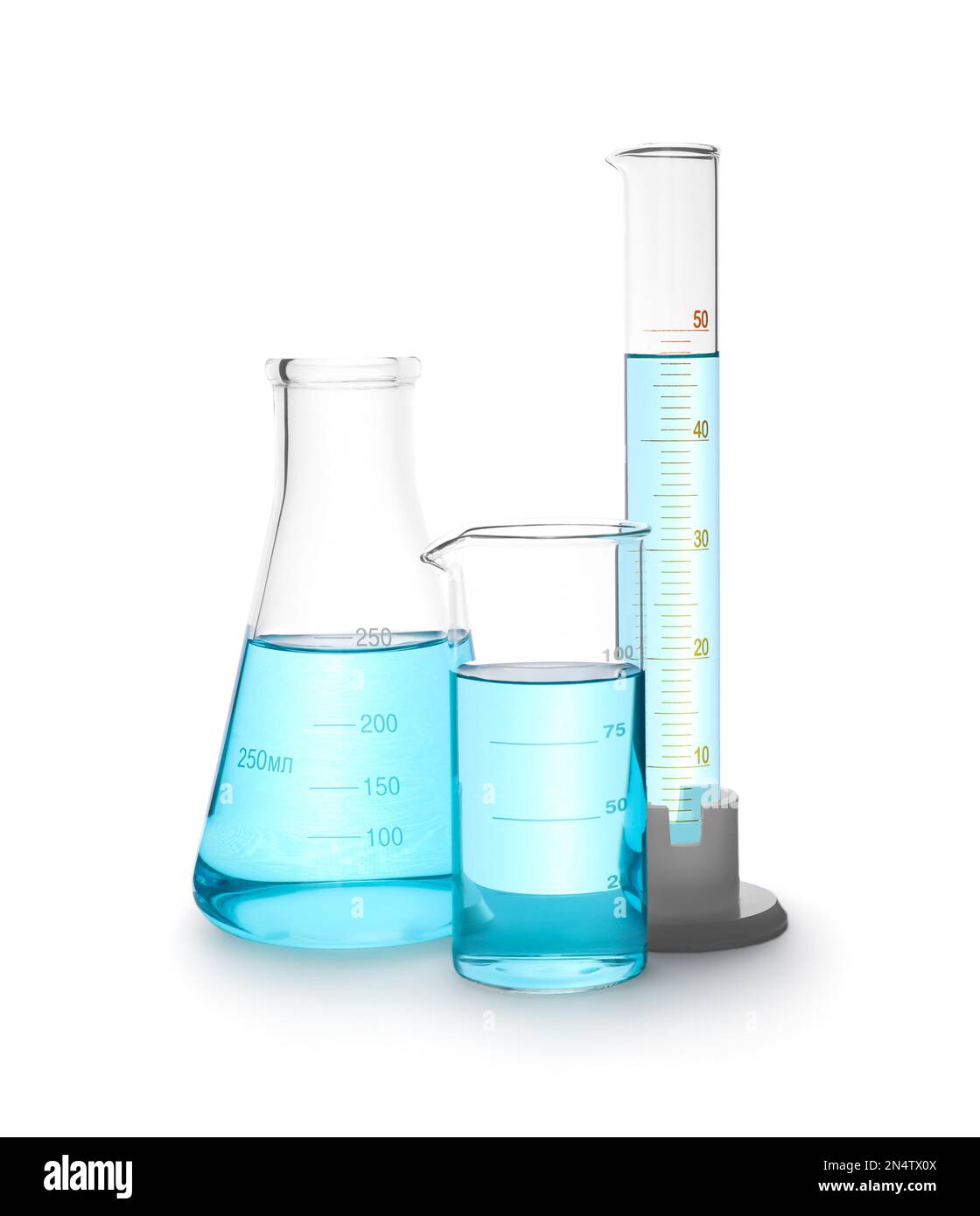 Different laboratory glassware with light blue liquid isolated on white ...